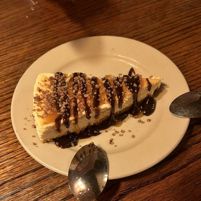 This cheesecake with chocolate drizzle and toffee bits isn't just dessert&mdash;it's what happiness would look like if it took solid form.