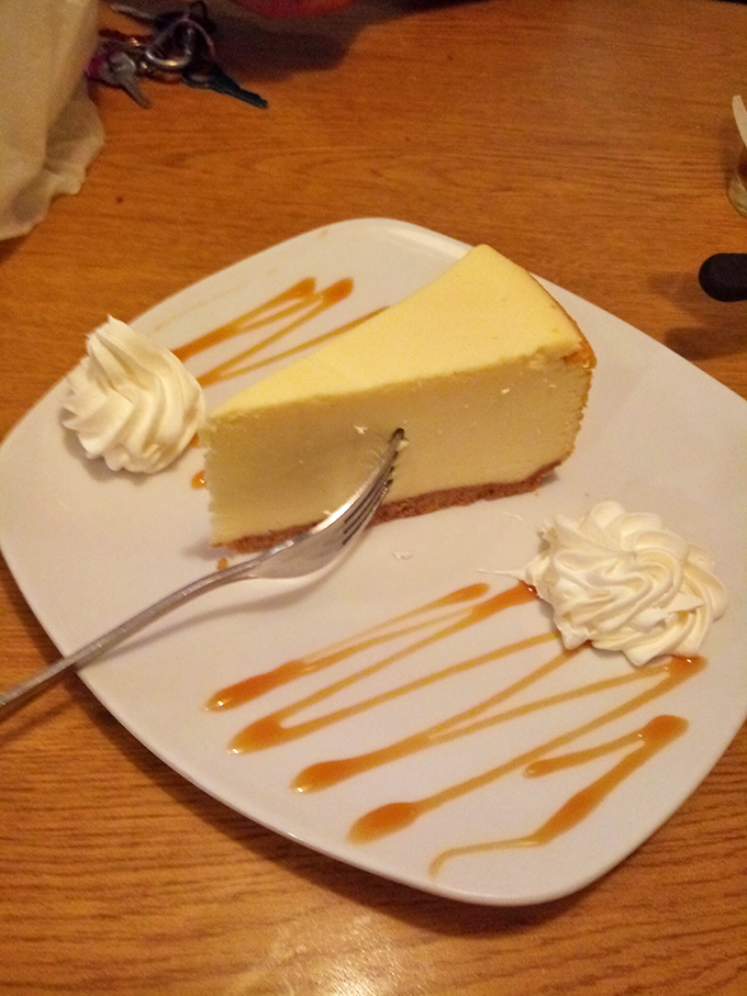 Cheesecake with caramel drizzle and whipped cream &ndash; the kind of dessert that makes you consider skipping the main course next time. Almost.