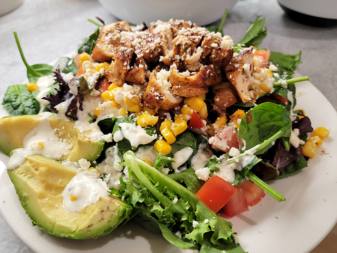 A salad that doesn't feel like punishment, loaded with avocado, grilled chicken, and enough goodies to make you forget you ordered something healthy.