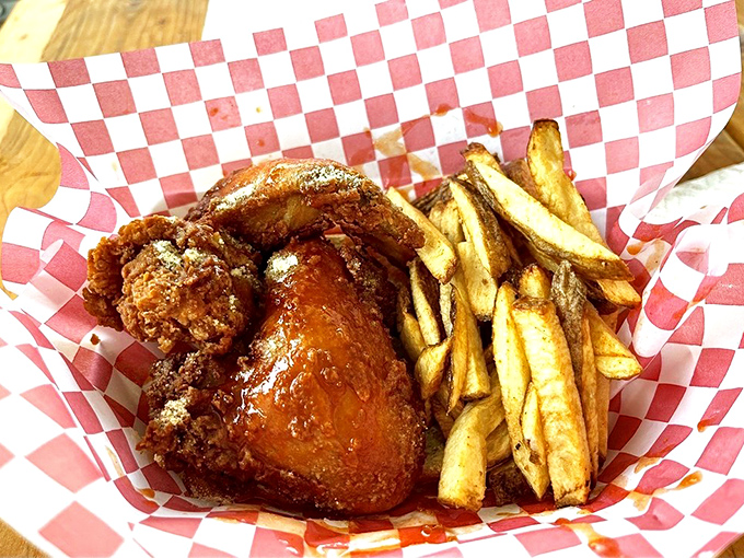 The holy trinity: perfectly fried chicken, hand-cut fries, and that little cup of sauce waiting to elevate everything even further.