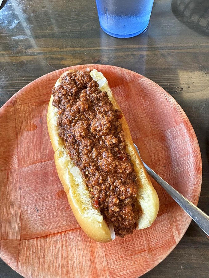 This chili dog isn't trying to be anything but its best self. No pretension, no gimmicks&mdash;just meaty, savory perfection on a wooden plate.