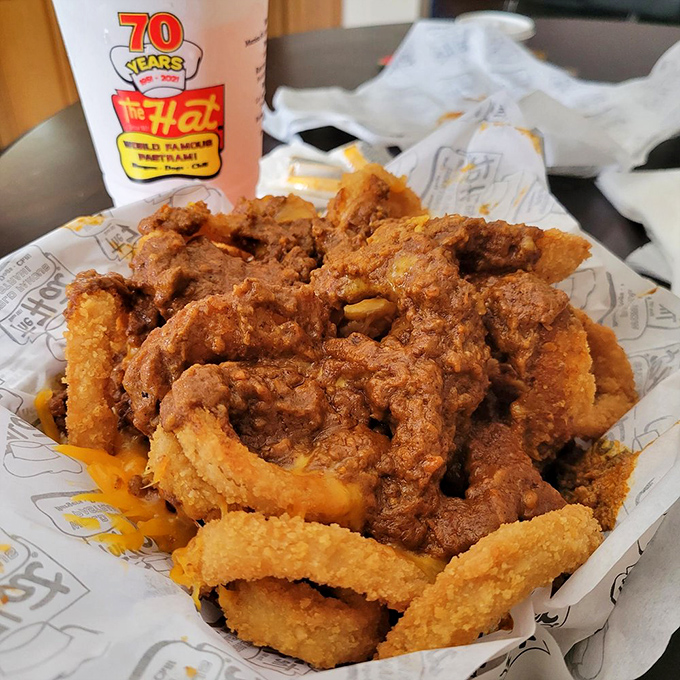 Onion rings wearing a chili tuxedo. This mountain of crispy, saucy goodness is why elastic waistbands were invented.