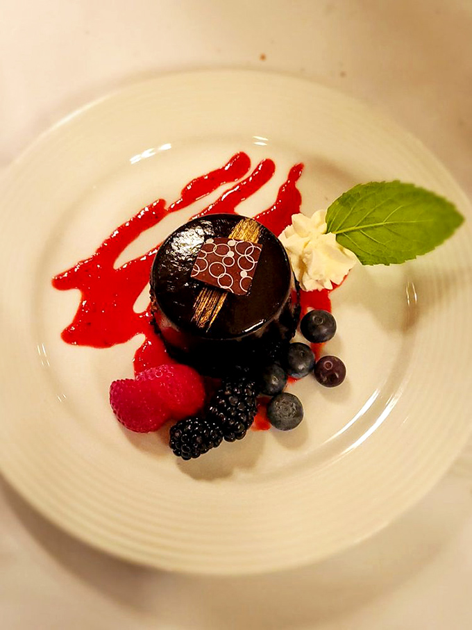 This chocolate torte isn't just dessert; it's a dramatic finale with fresh berries playing supporting roles in this sweet symphony of flavors.