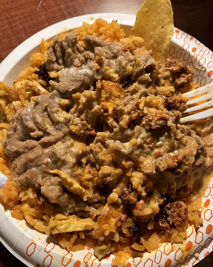 Chori pollo that doesn't just sit on the plate&mdash;it commands attention. That cheese sauce blankets the dish like a savory fog rolling over flavorful terrain.