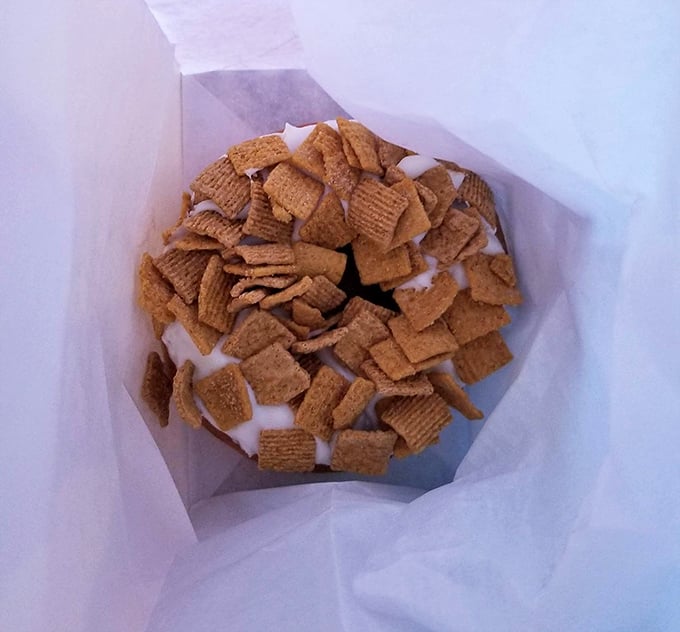 A perfect pairing: craft beer in a plastic cup alongside a maple bacon donut. Some marriages really are made in heaven.