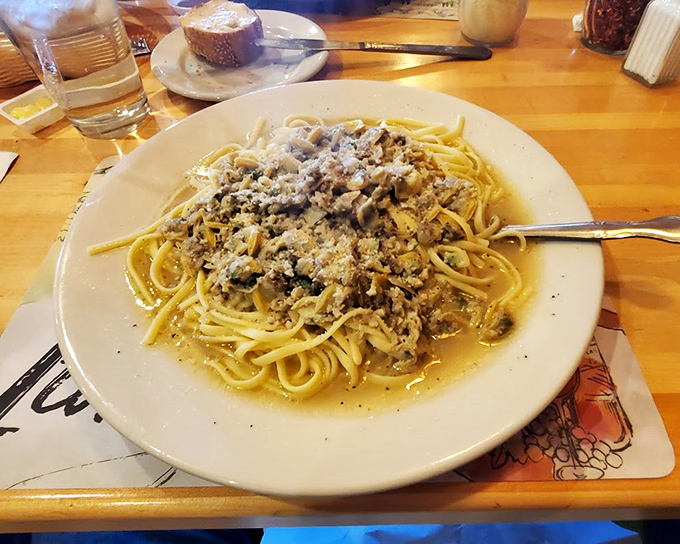 Linguine with clam sauce that transports you straight to coastal Italy, where the sea breeze carries the scent of garlic and white wine.