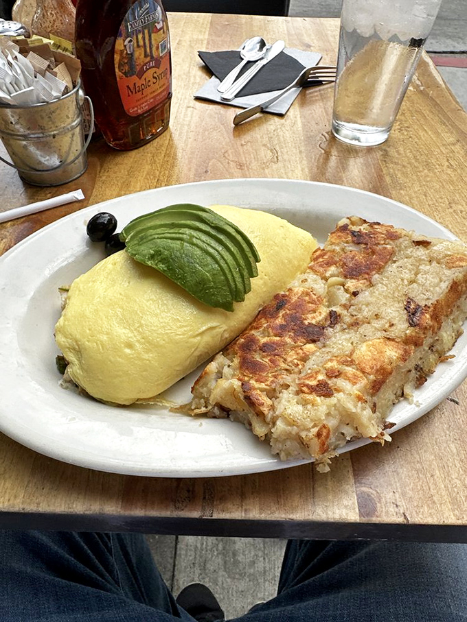 An omelet so perfectly executed it deserves its own slow-motion entrance sequence, paired with hash browns that achieved the ideal crisp-to-tender ratio.