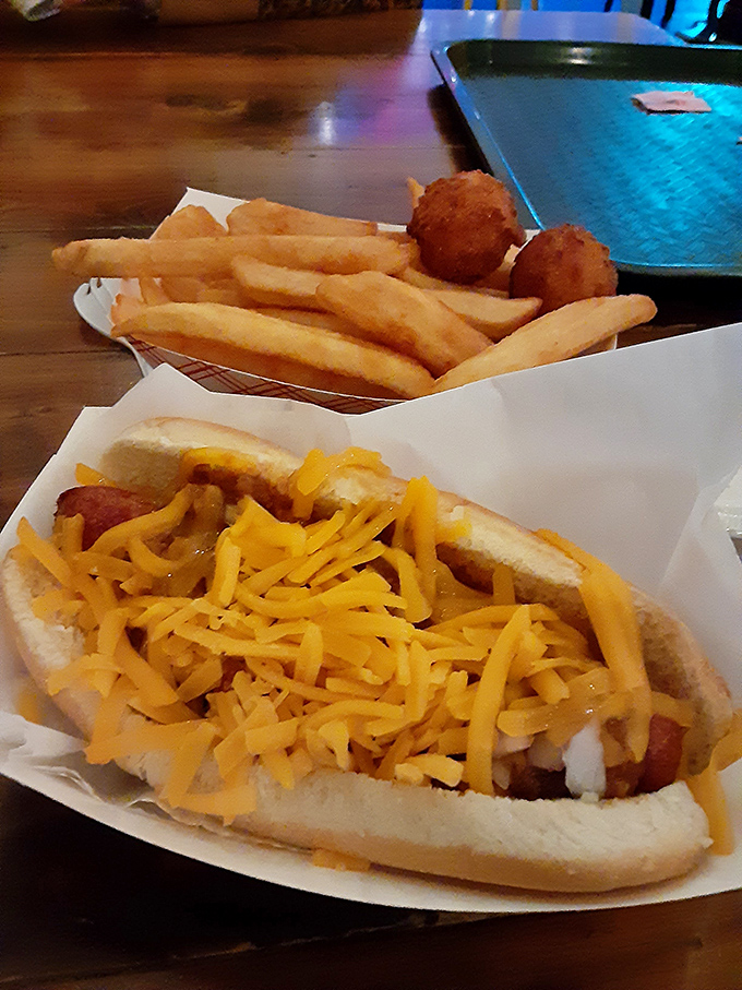 The humble hot dog gets the royal treatment with a blanket of melted cheese so generous it's practically tucking the sausage in for the night.