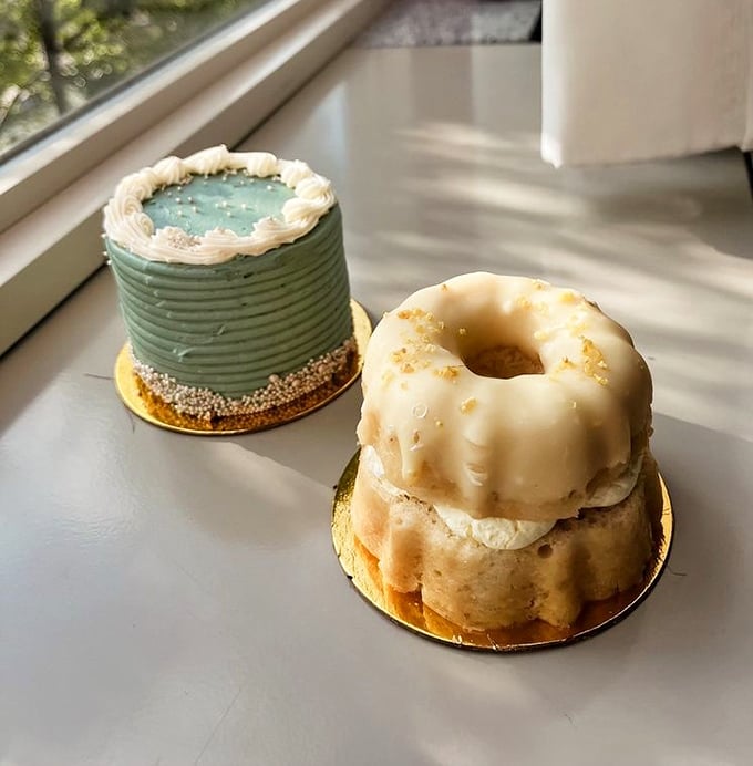Window-side treats catching the perfect light. That mint green frosting and glazed lemon bundt are calling your name from their gold pedestals.