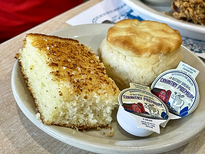 Southern hospitality on a plate: cornbread with a hint of sweetness alongside a biscuit that could convert a carb-avoider in one buttery bite.