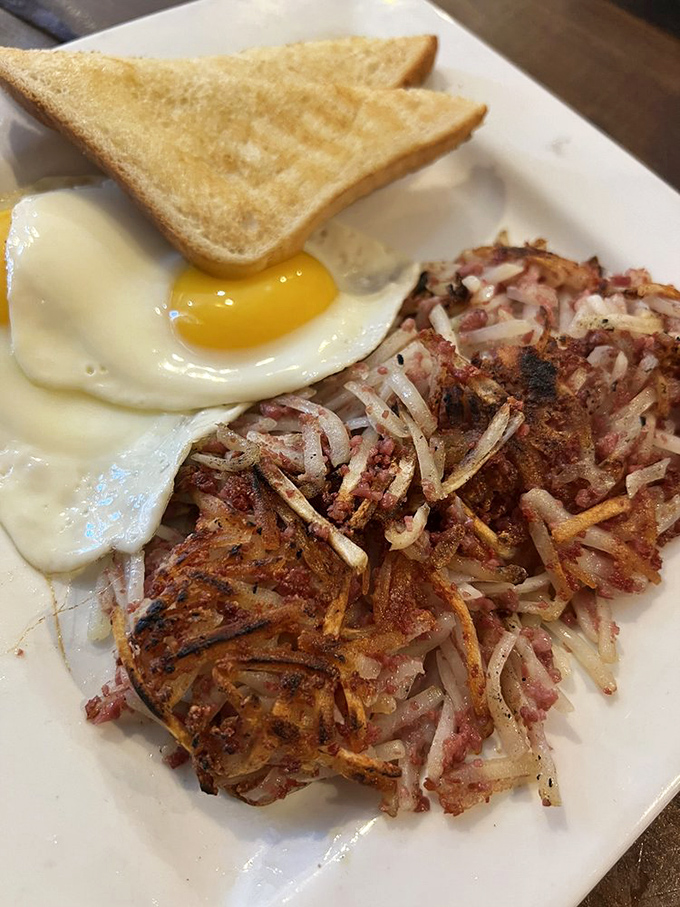 Corned beef hash with an egg on top: breakfast's way of saying "I love you" without using words.