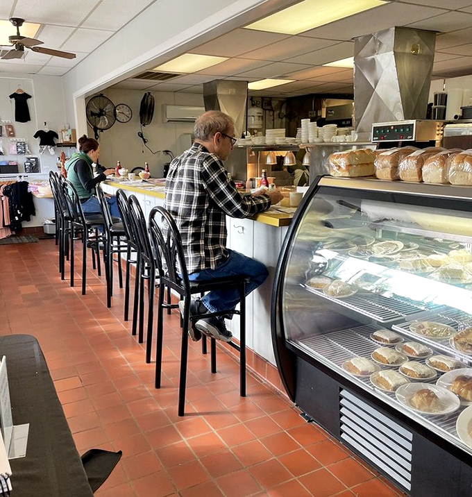 Counter seats where regulars become family and pie decisions are contemplated with the seriousness they deserve. That dessert case is not kidding around.