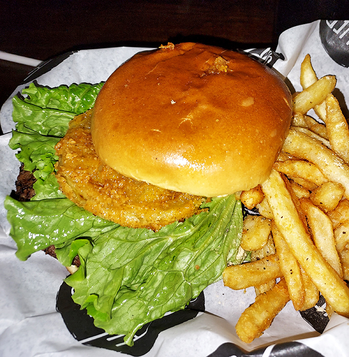 The Creaky Rocker Burger with its golden-brown bun and crispy onion ring is the kind of comfort food that makes Monday feel like Friday.