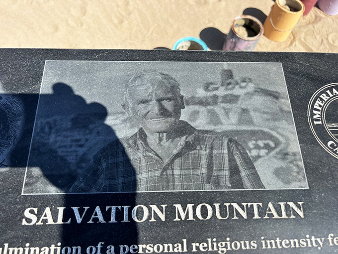 A memorial plaque honors the mountain's creator, whose vision transformed this patch of desert into a pilgrimage site for the curious and faithful alike.