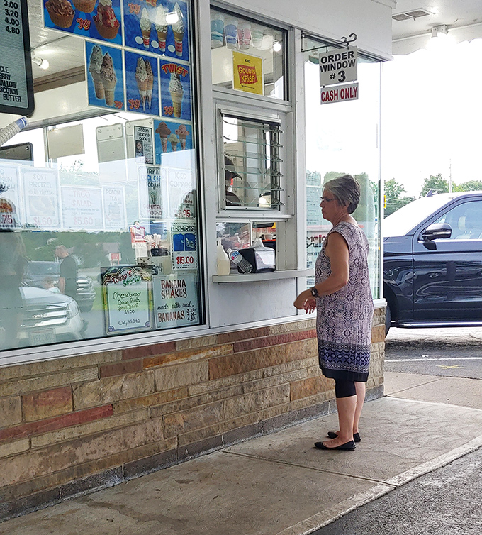 The timeless ritual of ordering at the window&mdash;where anticipation builds with each step forward in line.