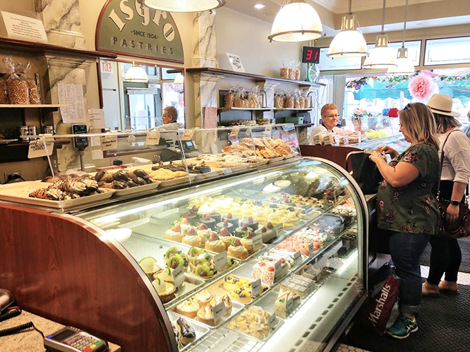 The curved display case at Isgro's has witnessed countless "I'll just have one" promises that quickly become "maybe just one more" realities.