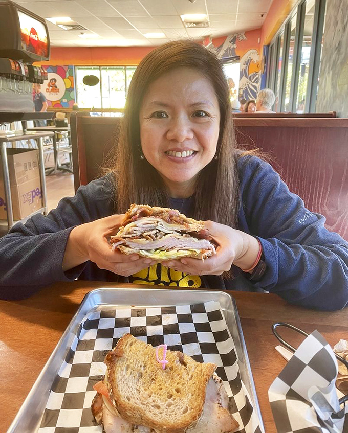 The joy of discovery is written all over her face. That sandwich isn't just lunch&mdash;it's the highlight of someone's Jacksonville adventure.