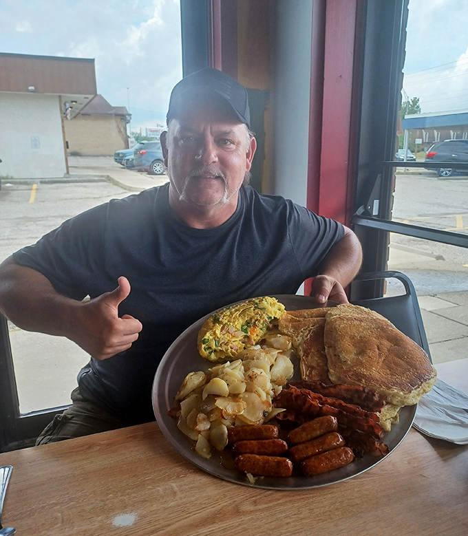 When your breakfast plate requires its own zip code. This happy diner giving the thumbs-up is all of us when the food exceeds expectations.