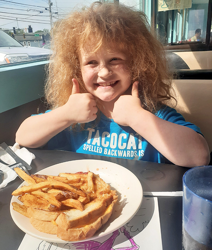 A young diner gives the universal thumbs-up of approval – the most honest food critic you'll ever meet.