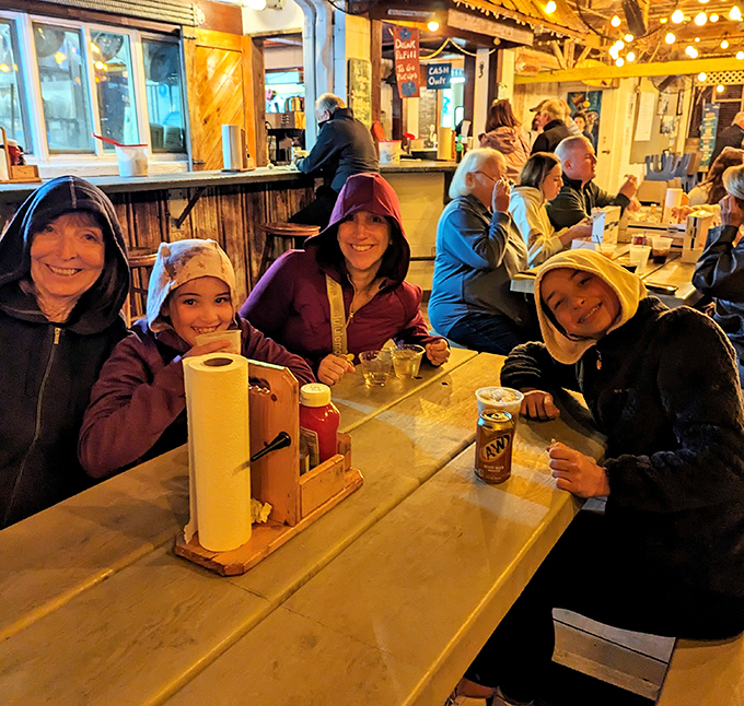 Happy diners bundled up on a cooler evening&mdash;proof that great seafood is worth braving any weather.