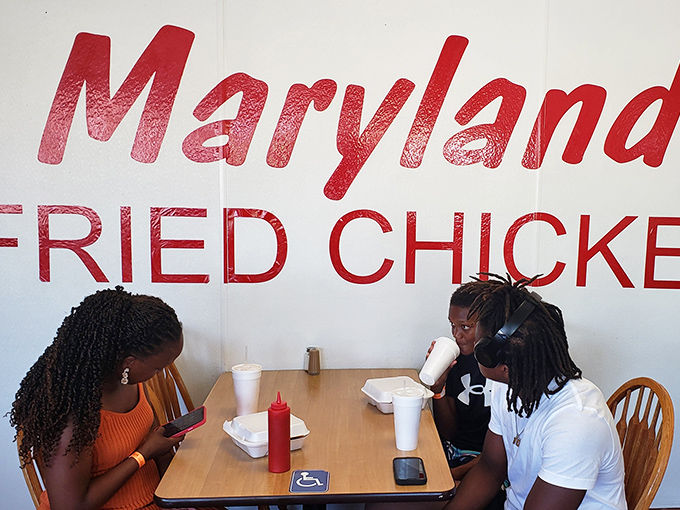 Locals gather beneath the iconic logo, participating in a Myrtle Beach tradition that transcends typical tourist dining.