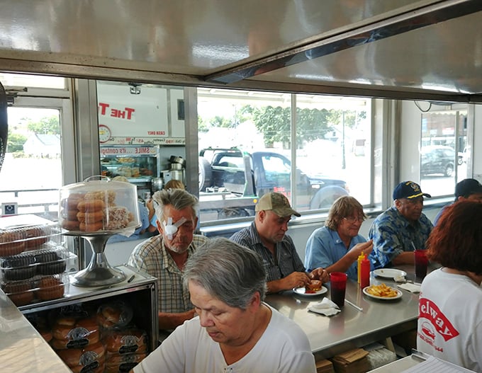 The counter seating creates a democratic dining experience where strangers become temporary neighbors united by the universal language of good food.