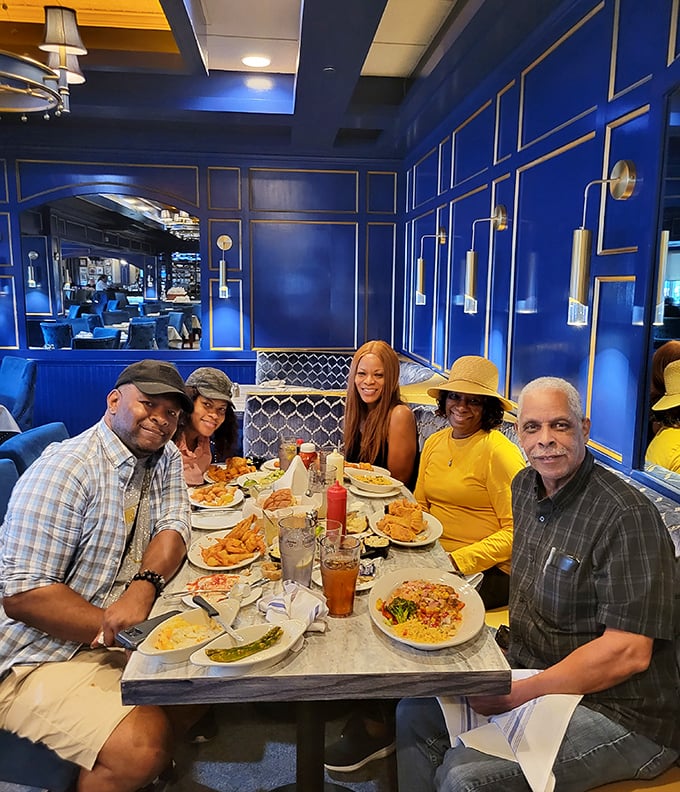 The vibrant blue dining room creates the perfect backdrop for family gatherings, where seafood brings everyone together around the table.