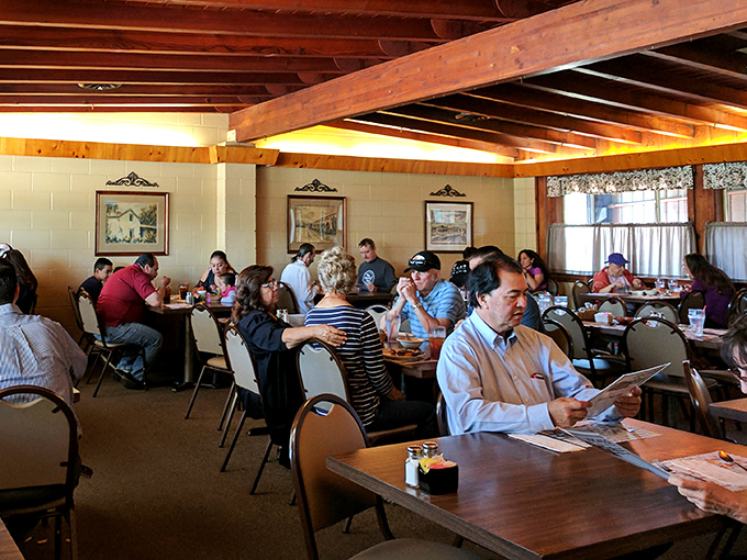 The dining room hums with the universal language of satisfaction. Notice how nobody's looking at their phones—they're too busy having religious experiences with beef.