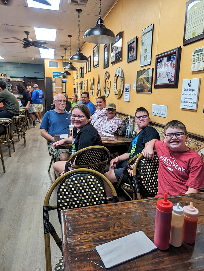 Happy diners experiencing the magic firsthand &ndash; that moment when food transforms strangers into a temporary family.