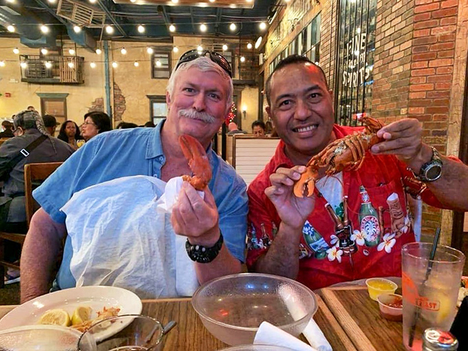 The restaurant brings together seafood enthusiasts who share one universal language: the triumphant smile of holding perfect lobster claws.