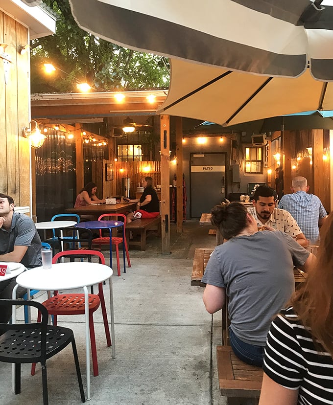 The patio at dusk&mdash;where string lights, good company, and the promise of pizza create that perfect "life is good" moment. 