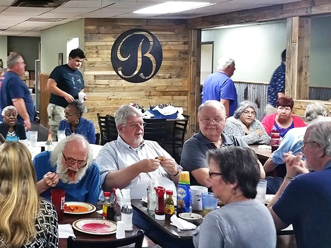 The dining room hums with the universal language of good eating. Notice how nobody's looking at their phones? That's the power of proper country cooking.