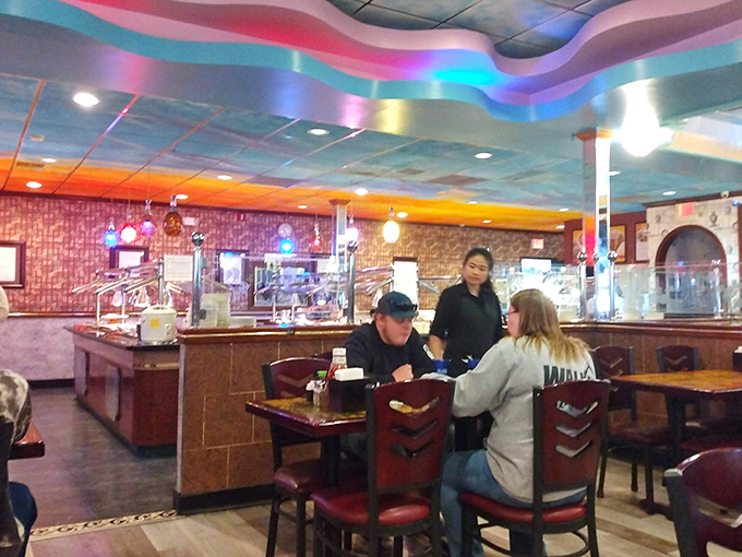 The buffet stations curve invitingly in the background while diners plot their next plate. Strategic eating at its finest.