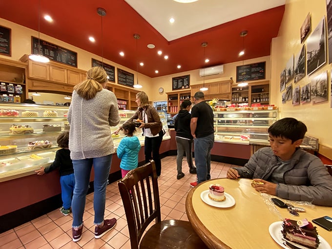 Happy customers contemplating life's sweetest decisions while surrounded by European confectionery treasures galore.