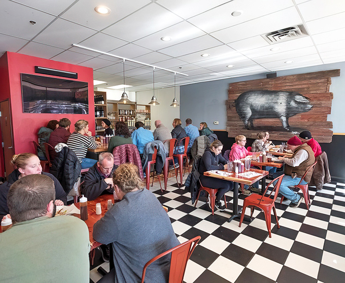 The checkered floor might say "diner," but the focused expressions of these diners say "serious barbecue pilgrimage." Note the clean plates.