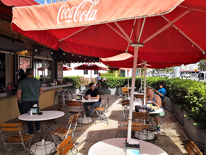 The lunch crowd knows what's up &ndash; Coca-Cola umbrellas providing shade for serious hot dog appreciation sessions.