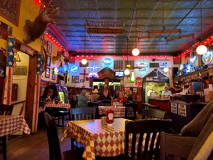 Evening at the Star Cafe transforms the dining room into a neon-lit sanctuary where strangers become neighbors over plates of Texas-sized comfort.