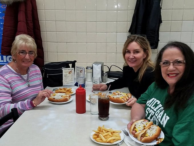 Three generations sharing the Lafayette experience. Some families pass down jewelry; Detroiters pass down their coney loyalty.