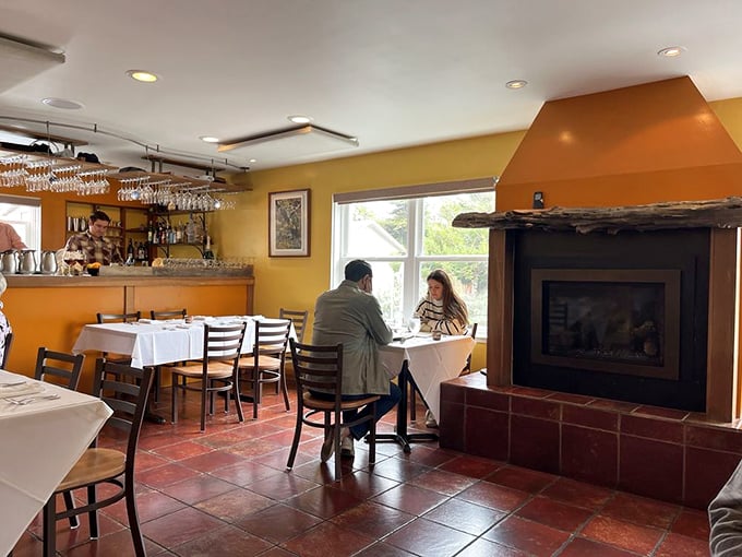 The fireplace adds a cozy counterpoint to the dining room's golden glow&mdash;perfect for those foggy Bodega Bay evenings.
