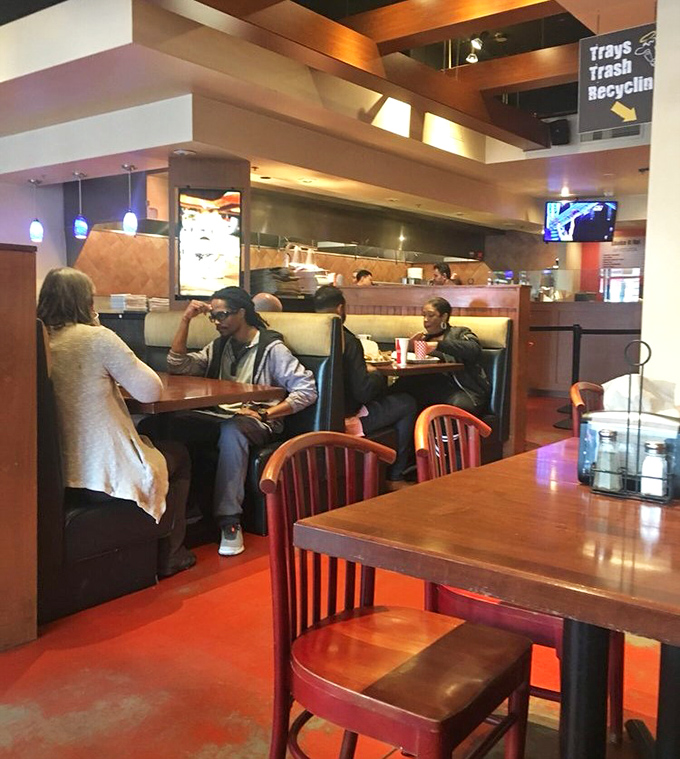 The dining area buzzes with the universal language of satisfied customers—the silent nods and focused eating that say more than words ever could.