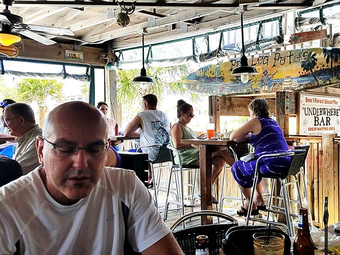 The "Underwhere Bar" offers prime people-watching with your pint, where beach stories improve with each round.