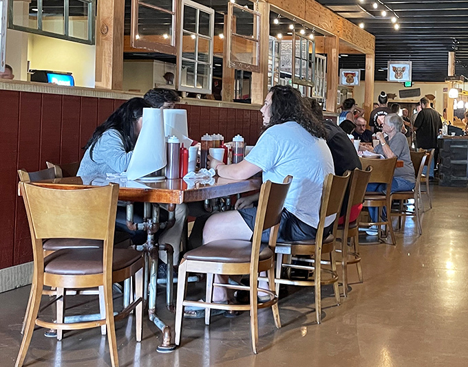 The universal language of barbecue brings strangers together at communal tables—silent nods replacing conversation while the eating is serious.