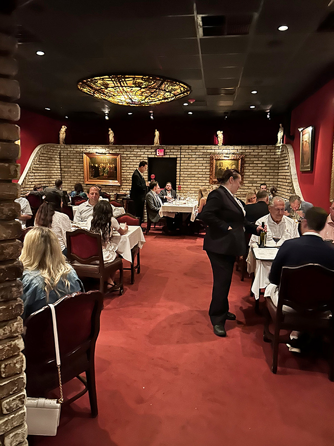 The dining room hums with the symphony of fine dining &ndash; servers in tuxedos gliding between tables like Fred Astaire in a kitchen.