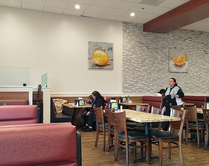 Modern, clean interiors with thoughtful touches like citrus artwork create an inviting atmosphere for diners seeking comfort and variety.