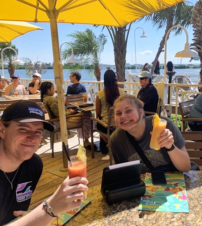 The outdoor patio—where strangers become friends, tropical drinks become Instagram stars, and Florida's weather finally makes sense as part of your dining experience.