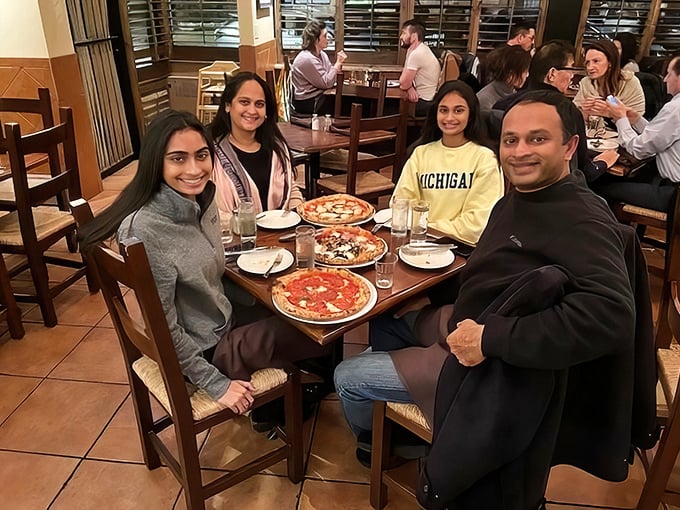 The universal language of pizza brings families together. Three generations of smiles around a table never gets old.
