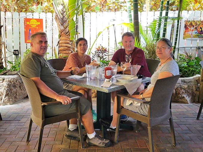 Happy diners enjoying their outdoor paradise &ndash; proof that great food creates instant friendships and lasting memories.