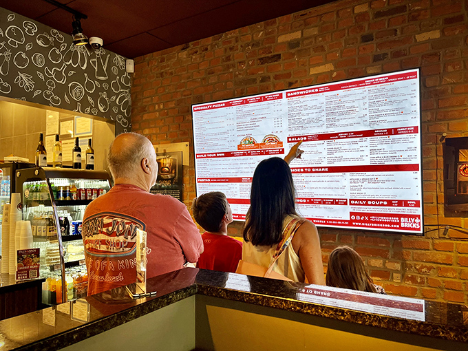 The family decision-making process in action: pointing at menu items with the concentration of NASA engineers planning a moon landing.