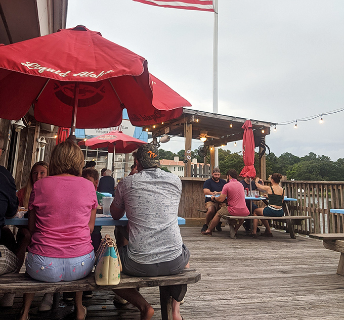 The outdoor deck at Chick's isn't just a dining area – it's a community gathering spot where strangers become friends over shared seafood platters.