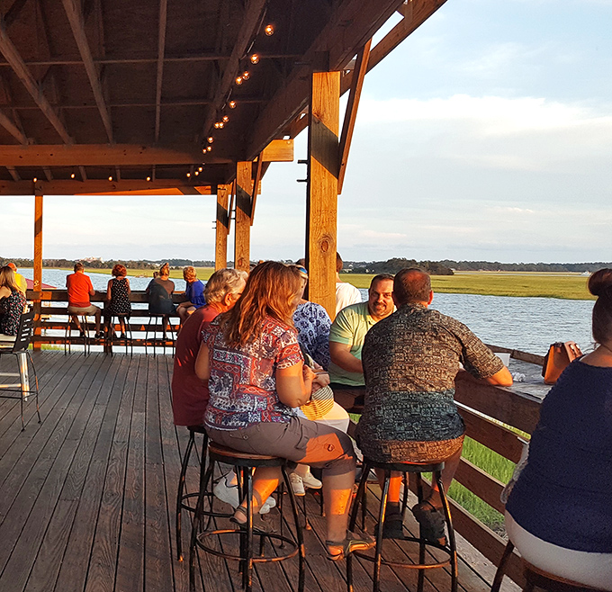 Sunset conversations over seafood &ndash; where strangers become friends and nobody's checking their watch. The Lowcountry's natural dinner theater.